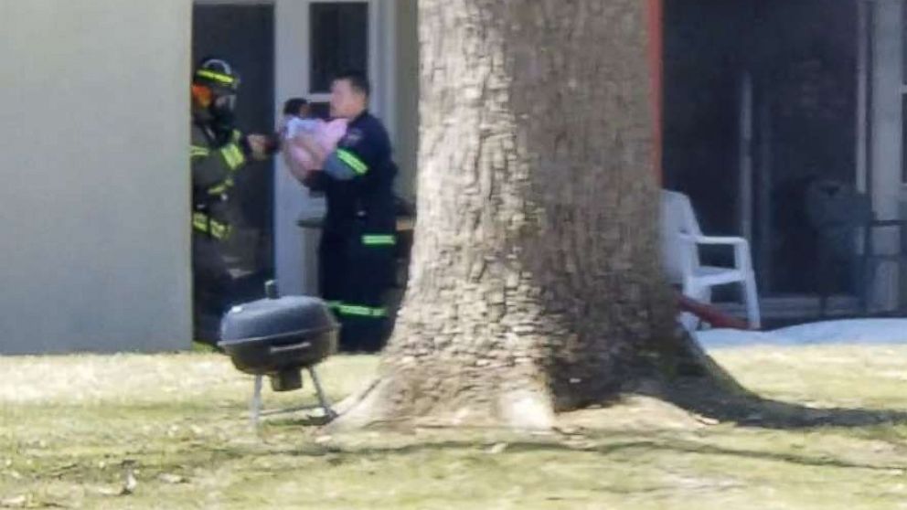 Assistant fire chief catches baby tossed from balcony in apartment fire ...